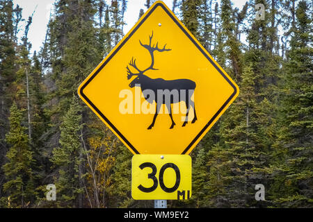 A highway sign warning of wild caribou Stock Photo - Alamy