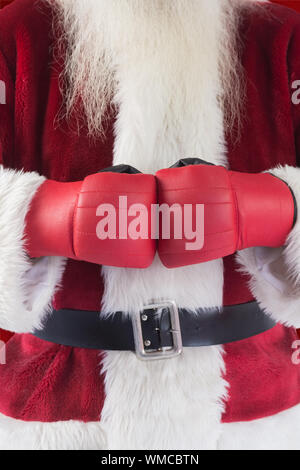 Santa Claus wears boxing gloves against red background Stock Photo - Alamy