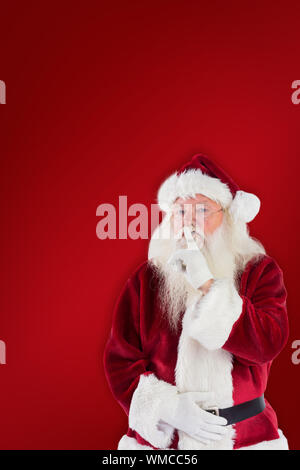 Santa asking for quiet to camera against green snowflake background ...