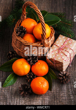Christmas decoration with gift box and mandarines Stock Photo - Alamy