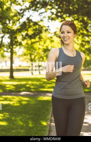 Portrait of a pretty redhead running Stock Photo - Alamy