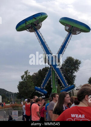 Families enjoying an amusement park ride at a carnival Stock Photo - Alamy