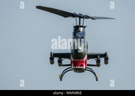AN air-to-air view of an AH-1 Cobra helicopter firing a missile during ...