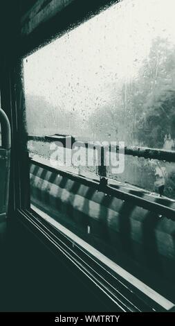 Rainy day bus window with water dripping from the glass Stock Photo - Alamy