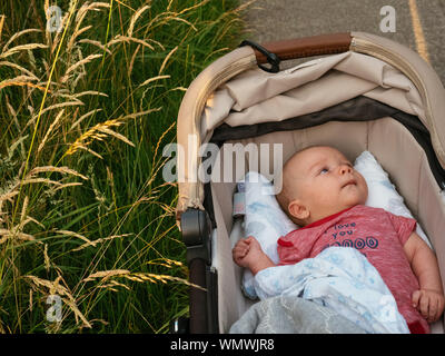happy family looking at a newborn yawning baby. concept of family ...