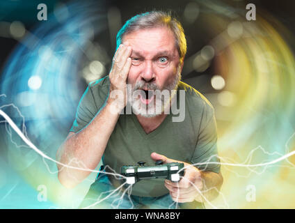 Emotional man with video game controller on grey background Stock Photo ...