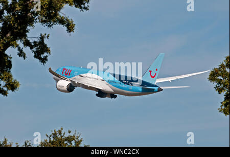 TUI Airways Boeing 787-8 Dreamliner at Manchester Airport as a family ...