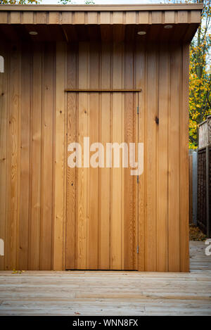 Oiled cedar timber cladding building with secret concealed door Stock ...