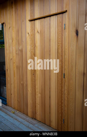 Oiled cedar timber cladding building with secret concealed door Stock ...