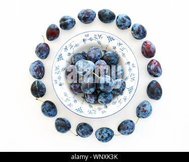 Flat lay with fresh plums on white background, top view Stock Photo - Alamy