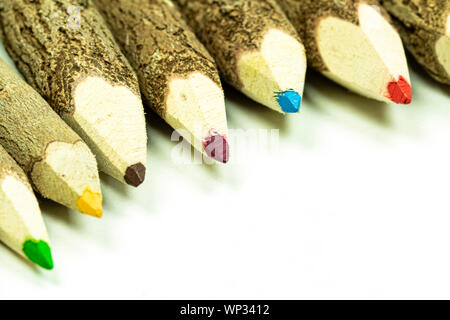 Colored pencils made from branches of trees isolate on white background ...
