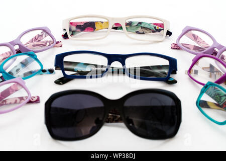 multiple colored eye glasses and sunglasses on white background. Eye ...