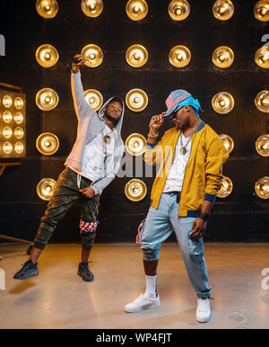 Two black rappers, perfomance in club with neon lights on background ...