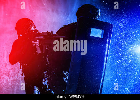 SWAT fighters officers hiding behind ballistic shield Stock Photo - Alamy