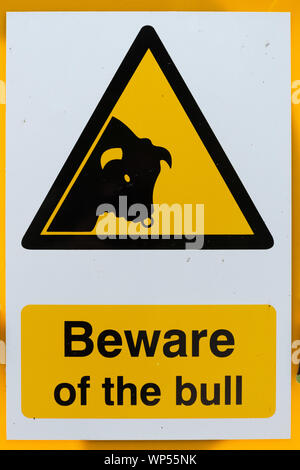 Beware of the bull sign signage on a gate Stock Photo - Alamy