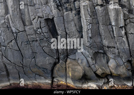 Abstract black lave basalt rock formation walls at the Ponta do ...
