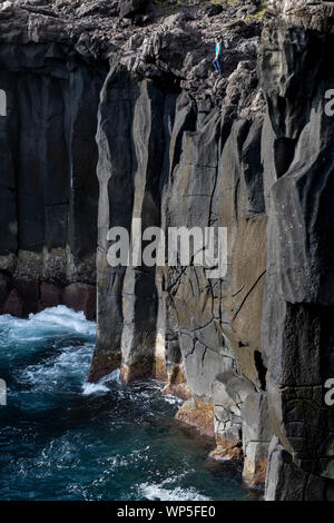 Abstract black lave basalt rock formation walls at the Ponta do ...