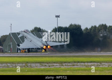 A Eurofighter Typhoon fighter jet lifts off from the runway, leaving a ...