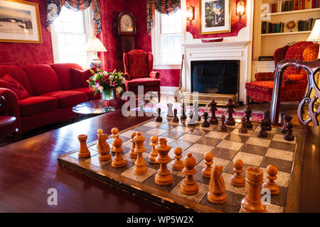 Living room with a big L shaped sofa and a chess board on the center ...