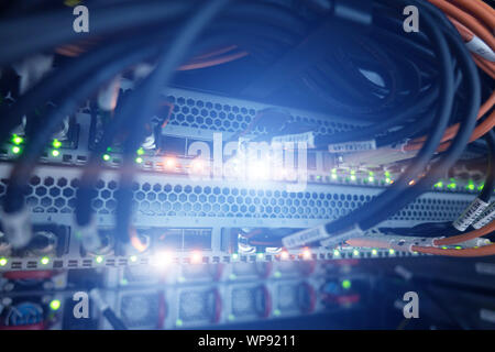 Fiber optical switch with connected FC cables in server room. Cross ...