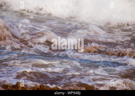 Strong afternoon, incoming tide with waves crashing on a tidal pool ...