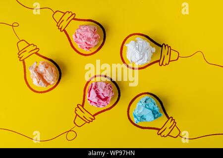 several light bulbs made of color paper balls on the table Stock Photo ...