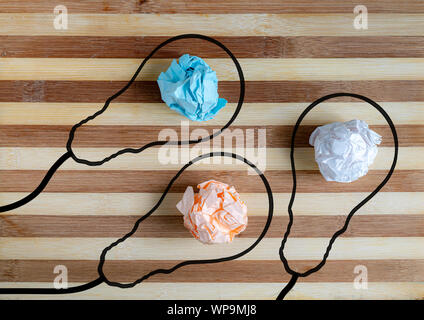 several light bulbs made of color paper balls on the table Stock Photo ...