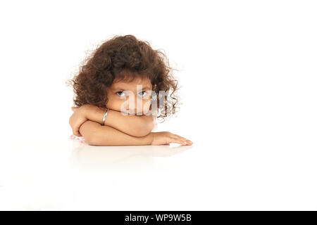 Girl resting head on arms at table Stock Photo - Alamy