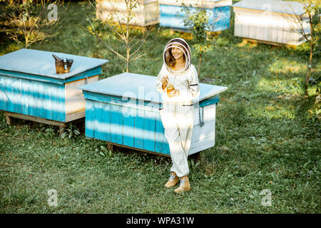 Beekeeper in full body uniform on white background Stock Photo - Alamy