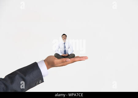 Young businessman employee doing yoga exercises during break Stock ...