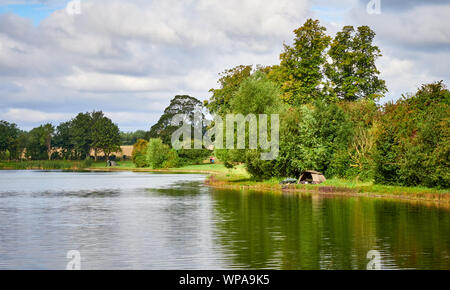 Anglers spending their spare time fishing as a hobby at the side of ...