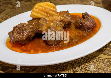 Burmese Myanmar lamb curry in plate, shrimp and dip in background Stock ...