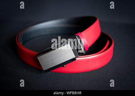 detail of men's red belt isolated over black background Stock Photo - Alamy