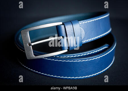 detail of blue belt isolated over black background Stock Photo - Alamy