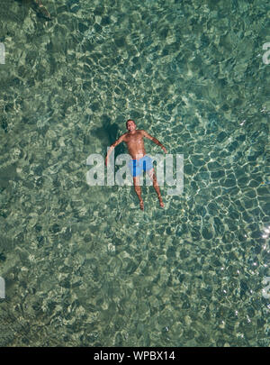 Chubby guy floating in the sea aerial Stock Photo - Alamy
