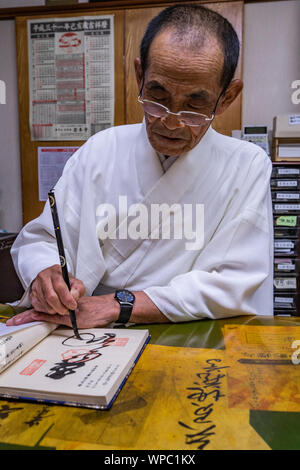 Japanese priest writing calligraphy Stock Photo - Alamy