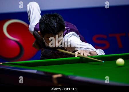 Chinese professional snooker player Wu Yize plays a shot at the Round 1 ...