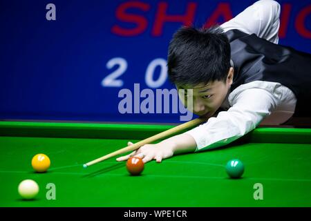 Chinese professional snooker player Wu Yize plays a shot at the Round 1 ...