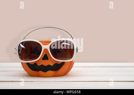 Halloween minimal concept with pink pumpkin, skull and cocktails ...