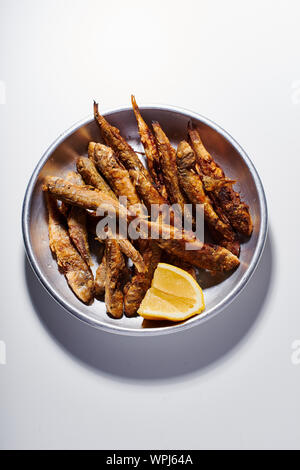 Red mullet fish deep-fried and served with lemon Stock Photo - Alamy