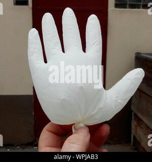 Hand Holding Blown Up Latex Glove Pink Stock Photo - Alamy
