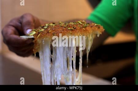 Amman, Jordan. 8th Sep, 2019. A baker makes kunafa at a store in Amman ...