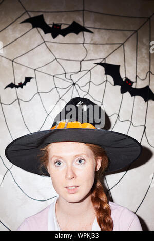 Beautiful woman dressed as witch for Halloween on light background ...