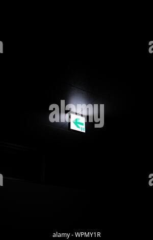 A vertical selective grayscale shot of a building with a red roof Stock ...