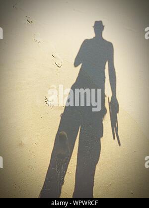 Shadow of the man with gun Stock Photo - Alamy