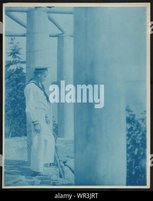 Maynard White in sailor suit standing beside a column on pergola Stock ...