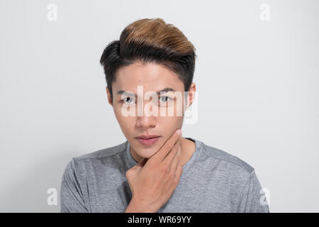 Shy man with his hand on his neck dissimulating Stock Photo - Alamy
