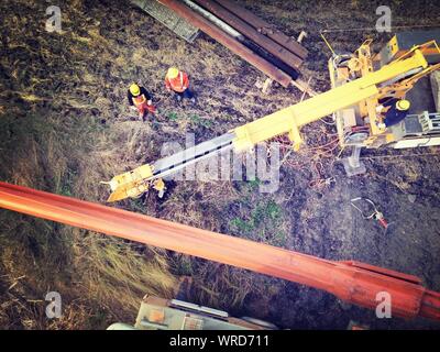 Overhead view of construction workers at construction site Stock Photo ...