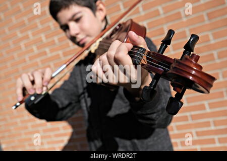 Teenager with violin in rape field Stock Photo - Alamy