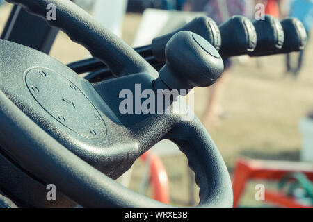 Operating control panels or levers and steering wheel in forklift or ...